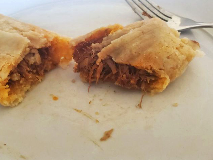 "Open sesame!" This tamale reveals its savory secrets, promising a flavor explosion that'll make your taste buds do the cha-cha.