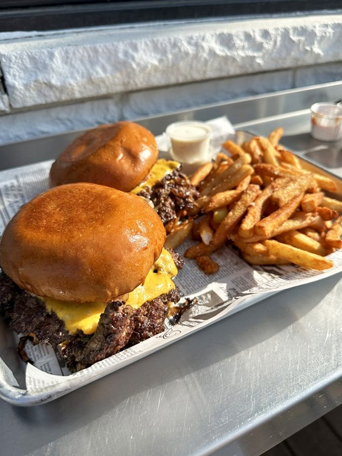 Double trouble never looked so delicious! These burgers are stacked higher than a Jenga tower at a giants' convention.