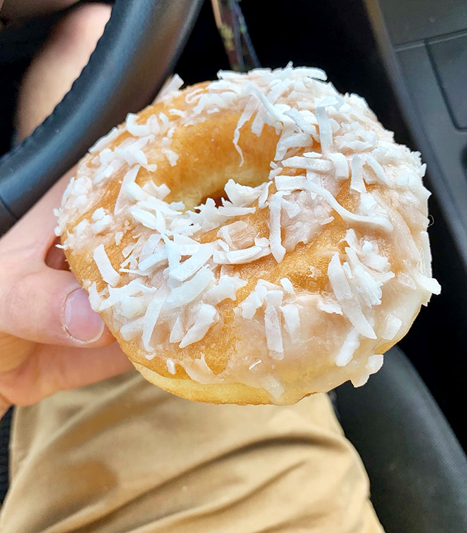 Snow-capped delight! This coconut-covered donut is like a tiny tropical vacation for your taste buds.