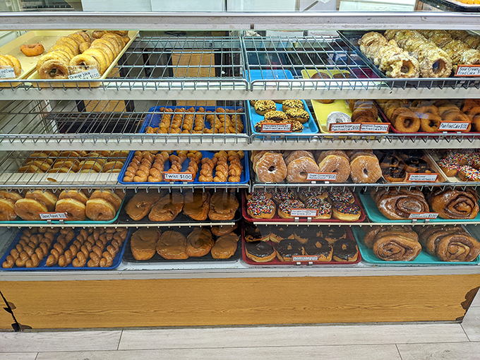 Welcome to carb heaven! This donut case is a sweet-toothed dream, where willpower comes to die and happiness is measured in sprinkles.
