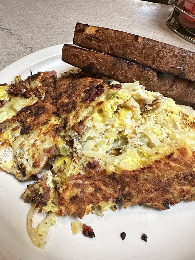 Breakfast gone wild! This plate is a beautiful chaos of eggs, potatoes, and toast &ndash; a morning mosh pit for your taste buds.