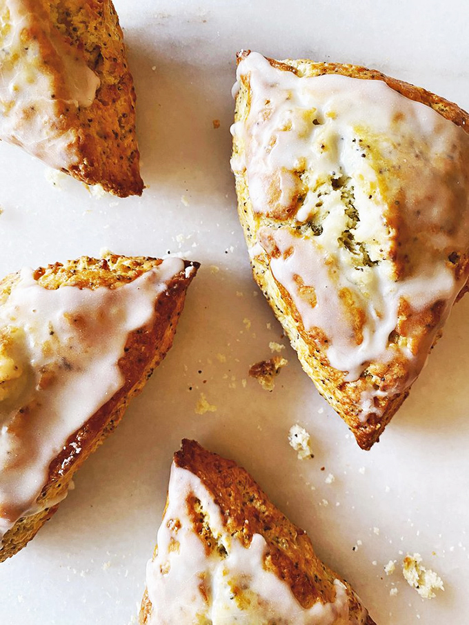 Lemon poppy scones that sing a zesty siren song! These glazed triangles of joy are the perfect balance of sweet and tart, like a dessert yin-yang.