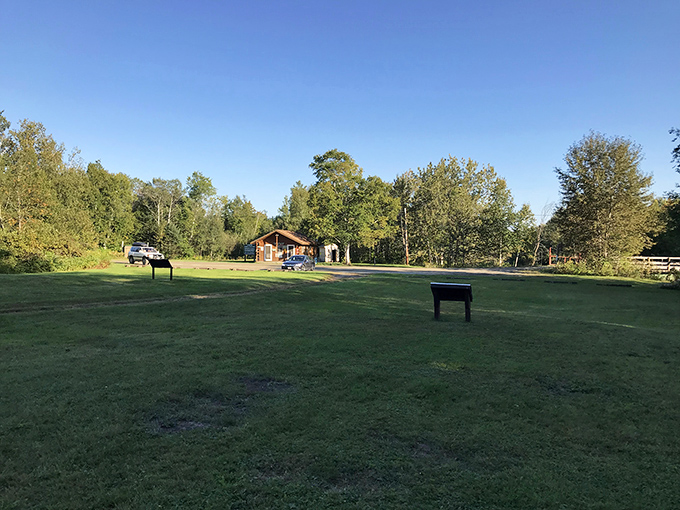 Who says history can't be a walk in the park? This serene landscape proves that even old iron works can have a soft, grassy side.