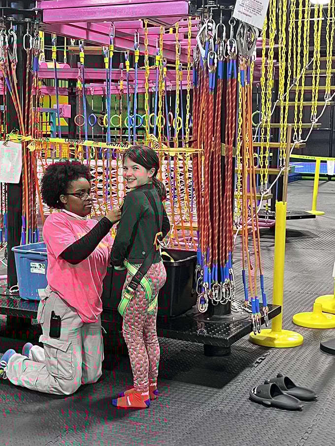 Safety first, fun always! The staff ensures everyone's ready for liftoff in this aerial playground.