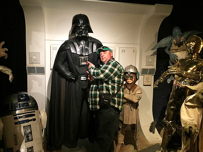 This brave soul's facing off against Darth Vader. Remember, in a lightsaber duel with a wax figure, you always win!
