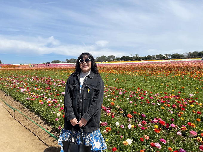 Smile and say "cheese"! This flower enthusiast found the perfect backdrop for a selfie that'll make her social media followers green with envy.