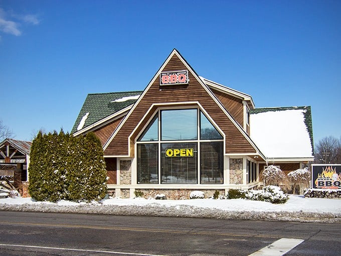 Snow or shine, Bad Brad's BBQ sign shines bright, guiding hungry travelers to a warm, meaty haven.