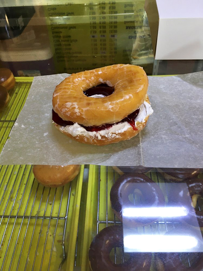 A donut identity crisis? Nope, just pure genius! This glazed beauty stuffed with whipped cream and raspberry is dessert disguised as breakfast.