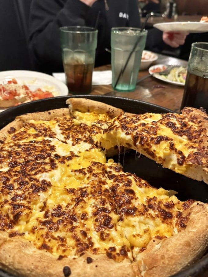 Mac 'n' cheese pizza: Because sometimes, adulting means combining your childhood favorites! This golden, gooey masterpiece is what comfort food dreams are made of.