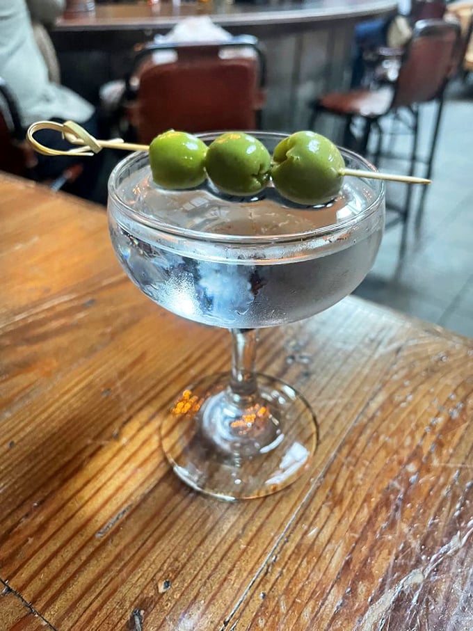 Three olive salute! This martini is so crisp and clean, it could moonlight as a bowling lane.