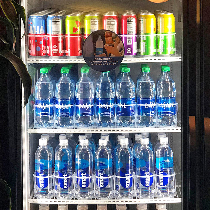 Thirst quenchers galore! This drink machine is like a rainbow of refreshment, ready to wash down your pizza adventure.