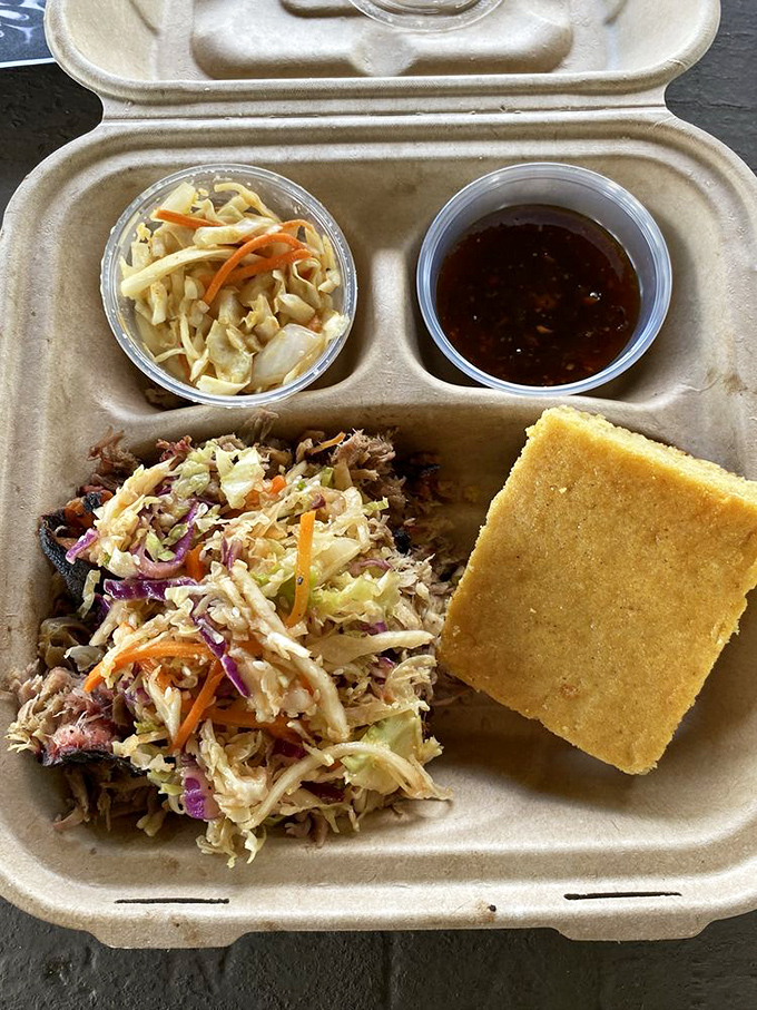 Pulled pork paradise! This mountain of meat is so tender, it practically melts on your fork. Pickles for zesty contrast? Yes, please!