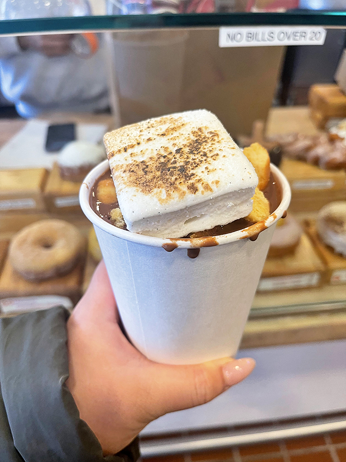Holy hot chocolate, Batman! This isn't just a drink, it's a warm hug for your insides, topped with a marshmallow pillow.