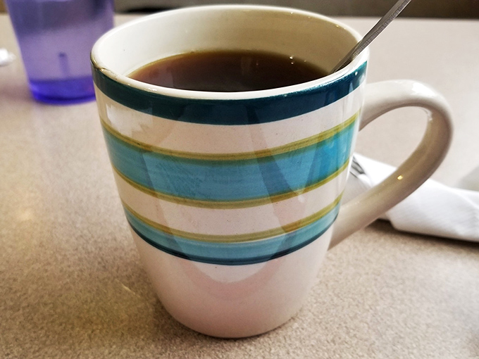 The elixir of life! This isn't just coffee; it's liquid motivation in a charming, striped mug that screams "Good morning, sunshine!"