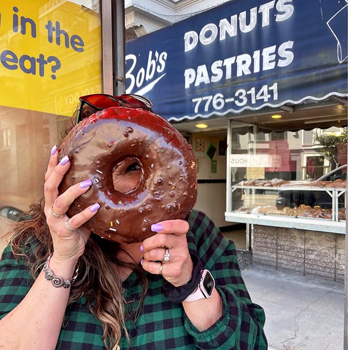 Holy hole-y delight! This mammoth chocolate-glazed beauty isn't just a donut; it's a personal floatation device for your taste buds.