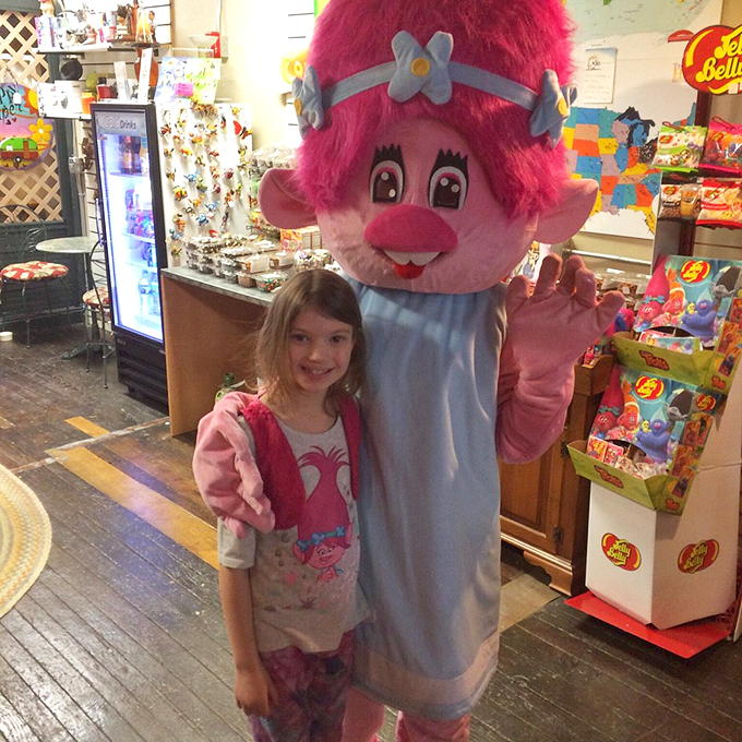 Making new friends in high places! This larger-than-life troll mascot is giving Mickey Mouse a run for his money in the huggability department.