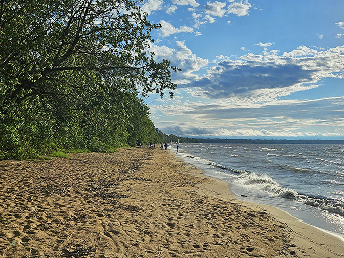 Lake Superior's beach: where 'taking a stroll' becomes an epic journey along nature's own infinity pool.