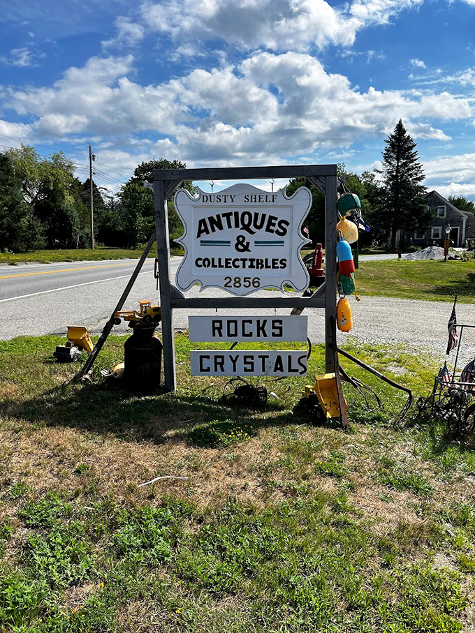 Even the sign can't contain its excitement! Rocks, crystals, and a world of wonders await behind this cheery roadside welcome.
