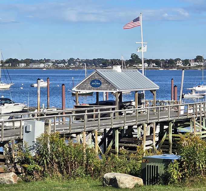 The flag snaps in the breeze at Dolphin Marina, where the harbor views are as fresh as the day's catch.