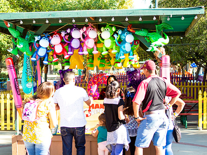 A carnival of colors! This prize booth is like a rainbow exploded, offering more stuffed animals than Noah's Ark on steroids.