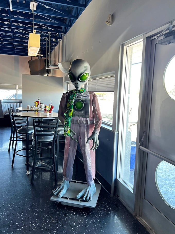Meet your extraterrestrial host! This alien decoration adds a touch of Area 51 charm to your dining experience. Don't worry, he's more interested in your leftovers than probing.