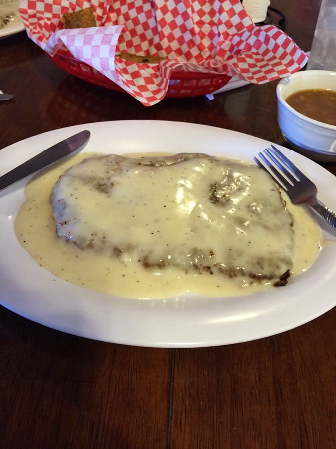Behold, the chicken fried steak of your dreams! Smothered in creamy gravy, it's like a warm, comforting blanket for your soul.
