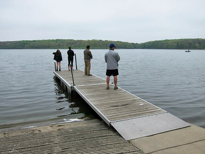 The fisherman's zen garden. Four figures, one mission: to out-patience the fish. It's like a real-life game of "Who can stand still the longest?"