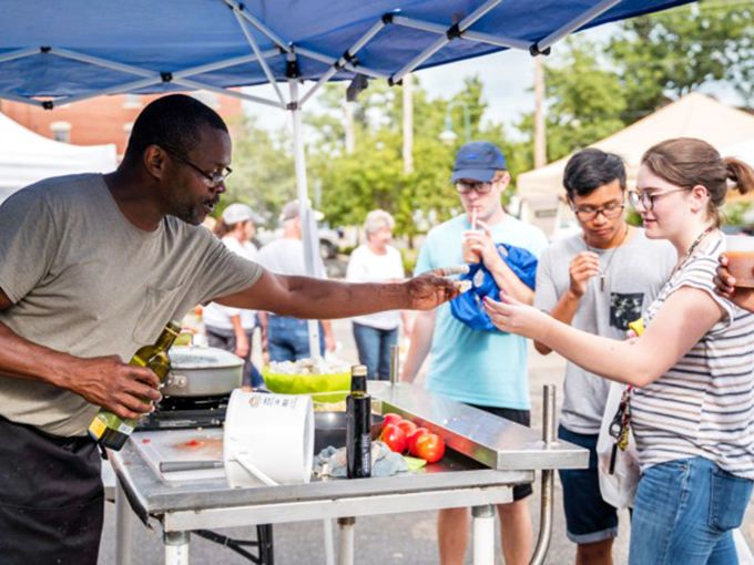 Bargain hunters, unite! This flea market scene is where treasure-seeking meets social hour, with a side of impromptu cooking demonstrations.