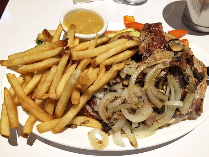 Who needs a time machine when you've got this plate? Juicy pork chops, golden fries, and caramelized onions transport you straight back to grandma's Sunday dinner.