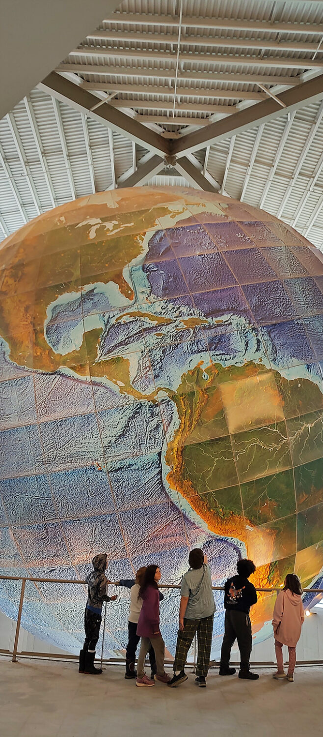 "Mom, can we take it home?" Young explorers stand in awe, probably plotting how to fit Eartha in their backyard.