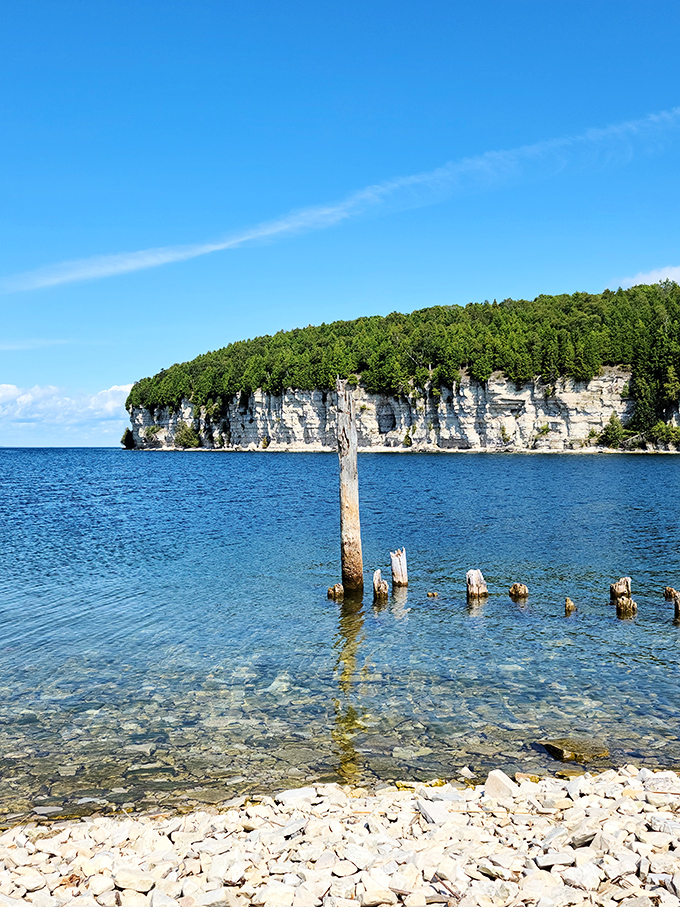 Nature's screensaver comes to life! This breathtaking vista of cliffs and crystal-clear waters is Mother Nature showing off her best work.
