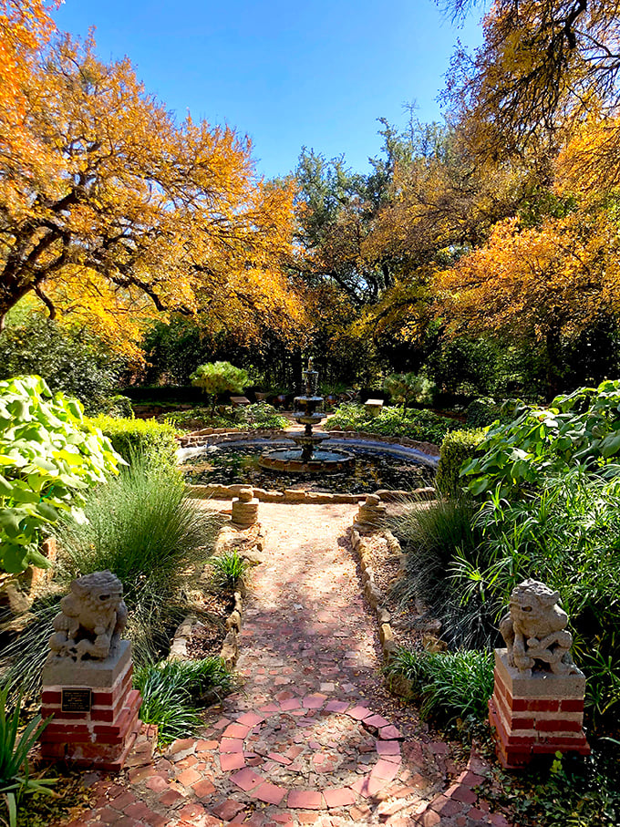 Step into a dreamscape of colorful autumn hues and soothing water sounds&mdash;this charming garden path feels like a step back in time. Peaceful, yet full of life, it's perfect for a moment of reflection.