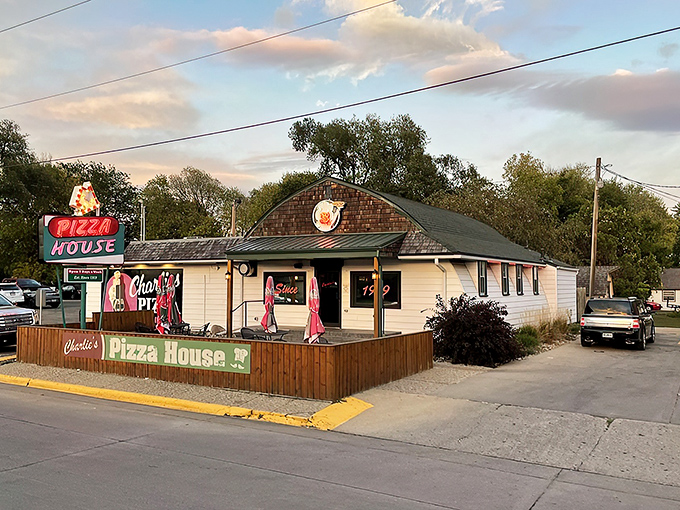 Neon dreams and pizza perfection! Charlie's Pizza House beckons like a lighthouse for the hungry, promising slices of heaven since 1959.