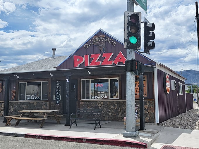 Neon dreams and pizza schemes! Old Nevada Pizza's exterior glows like a beacon of cheesy hope in the desert night.