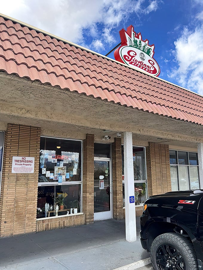 Welcome to pizza paradise! Giovanni's unassuming exterior hides a world of cheesy delights, proving you can't judge a pizzeria by its storefront.