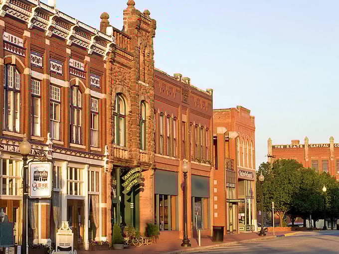 "Welcome to Guthrie: Where History Meets Hallmark!" This charming street scene could double as a movie set, with its ornate architecture and quaint storefronts straight out of a nostalgic dream.
