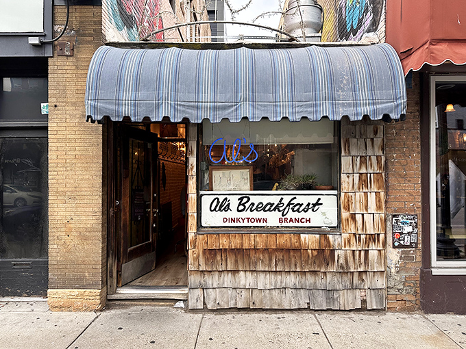 A blue-striped awning and weathered shingles? This isn't just a diner, it's a time machine disguised as breakfast central!