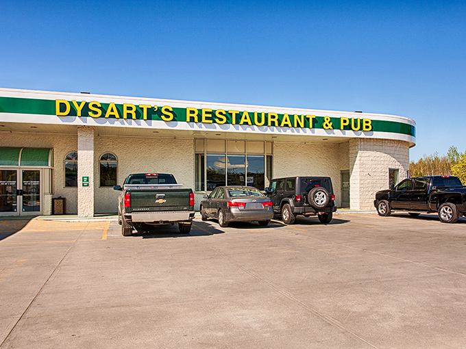 Welcome to flavor town! Dysart's iconic yellow sign beckons like a lighthouse for hungry souls seeking comfort food paradise.
