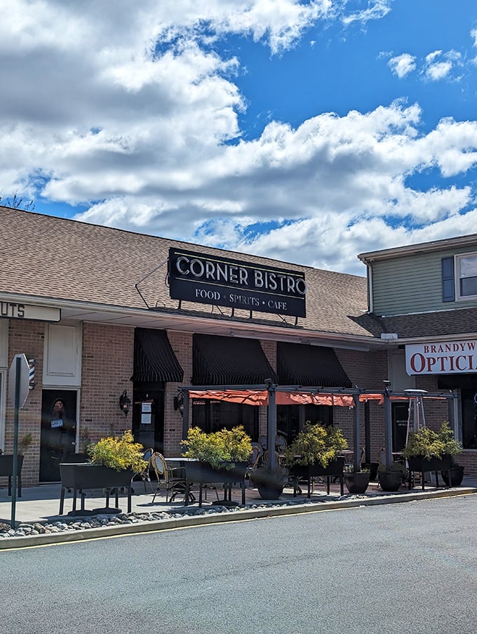 A slice of Parisian charm in Wilmington! Corner Bistro's inviting facade promises culinary delights and cozy evenings under those chic Cinzano umbrellas.