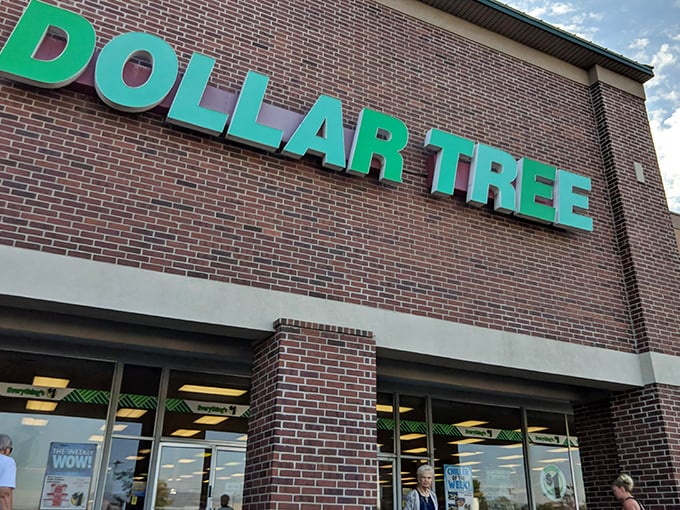 The glowing green sign of Sandy's Dollar Tree beckons like a neon promise of budget-friendly treasures waiting to be discovered inside.