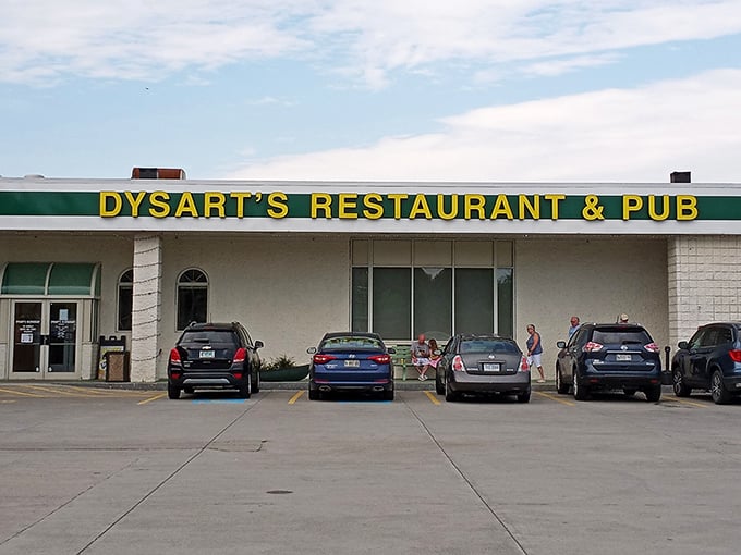 Welcome to flavor town! Dysart's iconic yellow sign beckons like a lighthouse for hungry souls seeking comfort food paradise.