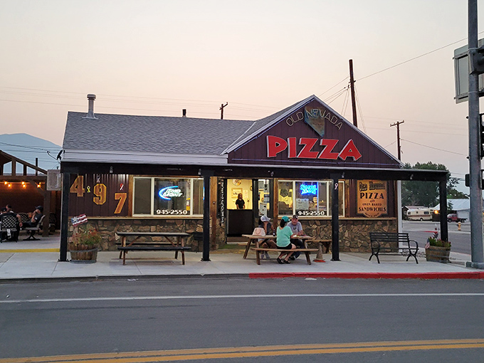 Neon dreams and pizza schemes! Old Nevada Pizza's exterior glows like a beacon of cheesy hope in the desert night.