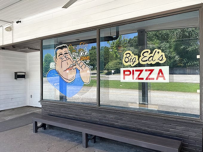 Welcome to flavor town! Big Ed's Pizza beckons with its charming storefront, complete with a caricature that's larger than life - just like their pizzas.