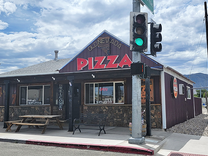 Neon dreams and pizza schemes! Old Nevada Pizza's exterior glows like a beacon of cheesy hope in the desert night.