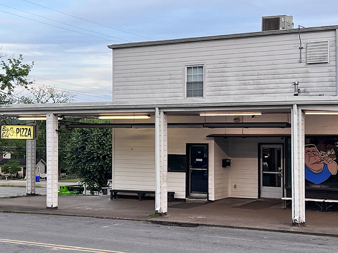 Welcome to flavor town! Big Ed's Pizza beckons with its charming storefront, complete with a caricature that's larger than life - just like their pizzas.