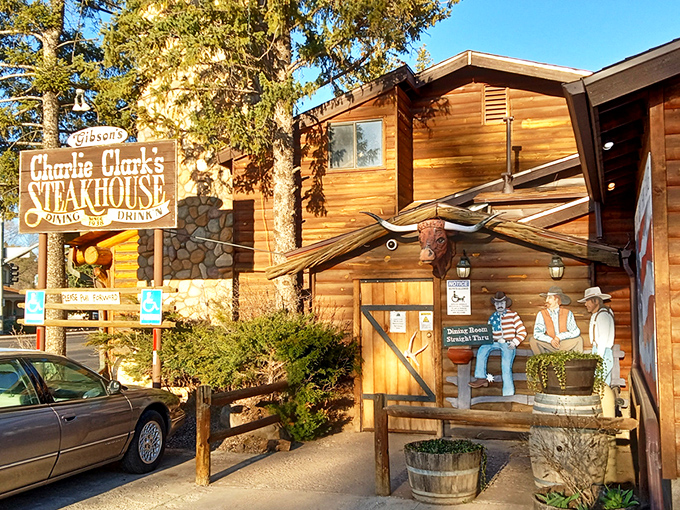 A rustic log cabin meets gourmet paradise! Charlie Clark's Steakhouse beckons with its weathered sign and promise of mouthwatering delights. Who knew heaven had a parking lot?
