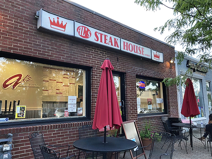 The burgundy awning and stone facade of Al's whispers "come inside" with more persuasion than any flashy neon sign ever could.