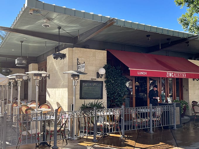 A Parisian postcard in the Arizona desert! Zinc Bistro's charming exterior beckons with its red awning and inviting patio, promising a culinary journey without the jet lag.