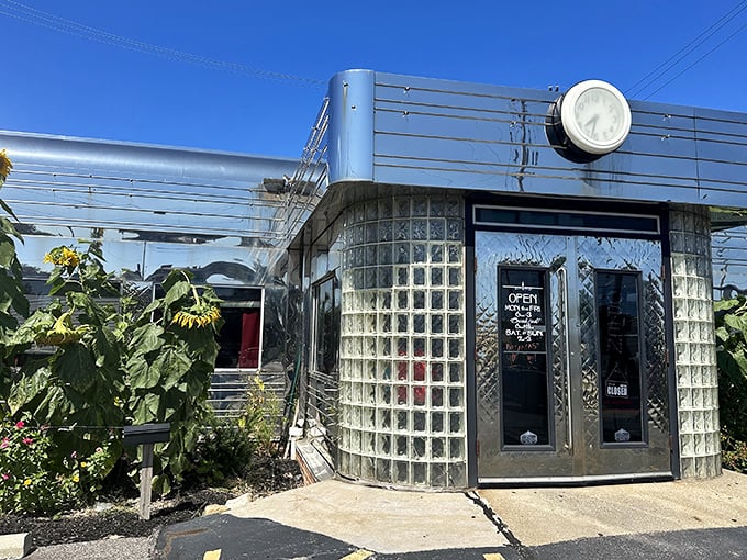 The gleaming stainless steel exterior shines like a beacon of breakfast hope, complete with classic glass block windows and vintage clock.