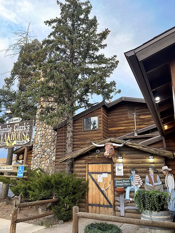 A rustic log cabin meets gourmet paradise! Charlie Clark's Steakhouse beckons with its weathered sign and promise of mouthwatering delights. Who knew heaven had a parking lot?